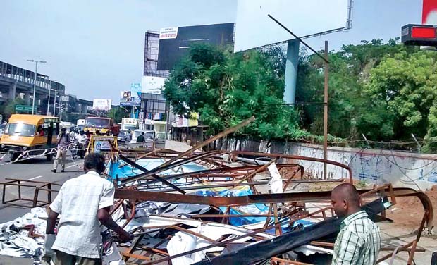 Pilots unhurt as hoarding falls on car