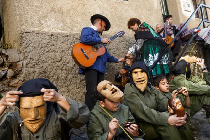 Spaniards parade the street celebrating traditional mask festival