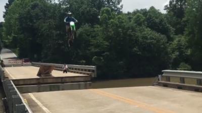 Thrill-seeking stunt bikers jump over 72-foot broken bridge