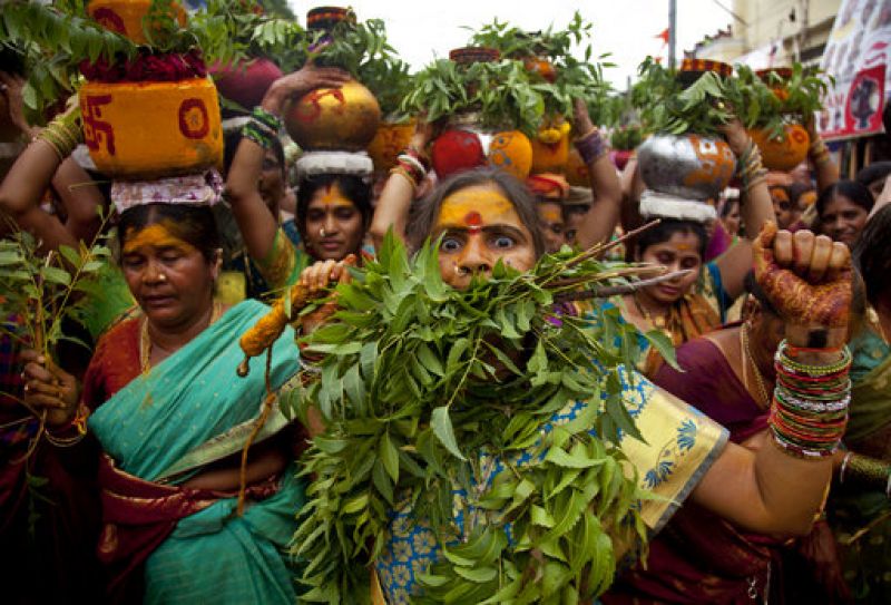 Hindu devotees perform sacred rituals during Bonalu festival in Hyderabad