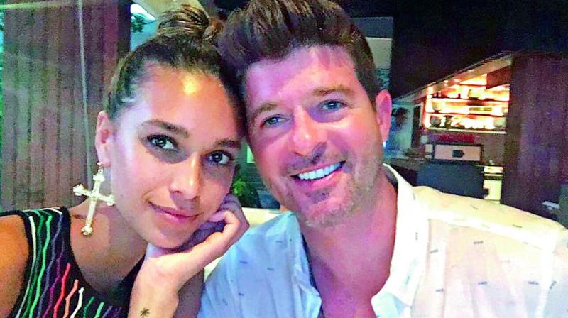 April defends age gap between her and Robin Thicke